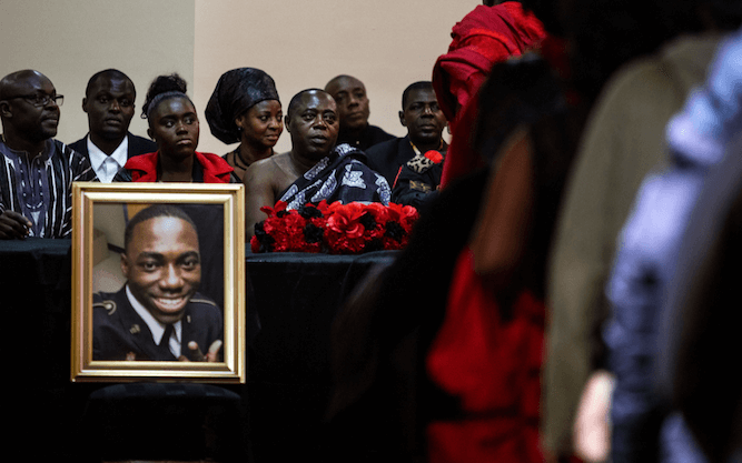 Kwabena Mensah, Mr. Mensah’s father, sitting behind his son’s portrait ...